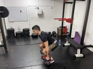 Suitcase Squat Exercise Guide: Muscles Worked, Benefits, Alternatives
