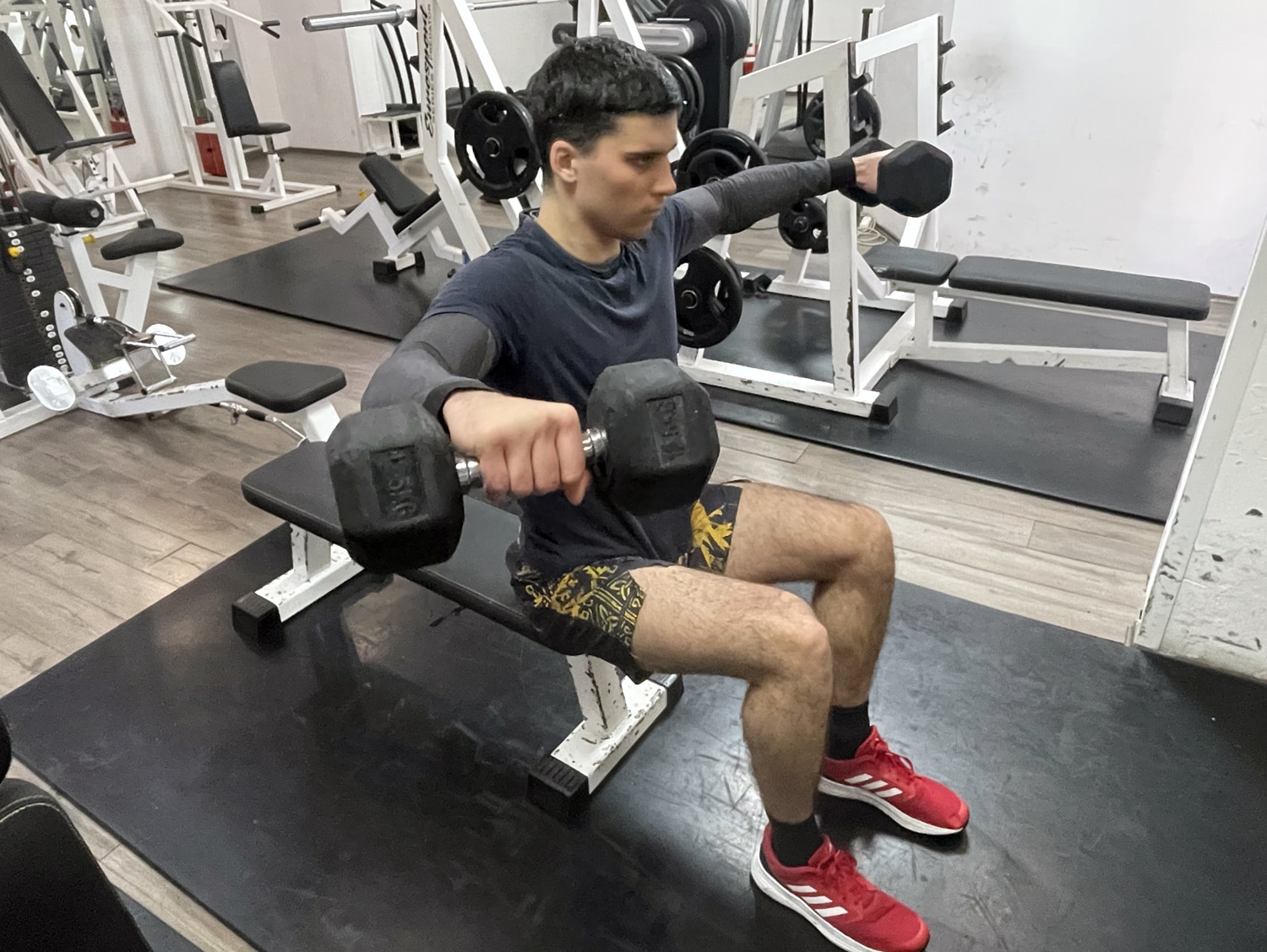 Seated Dumbbell Lateral Raise Guide: How To, Benefits, Alternatives